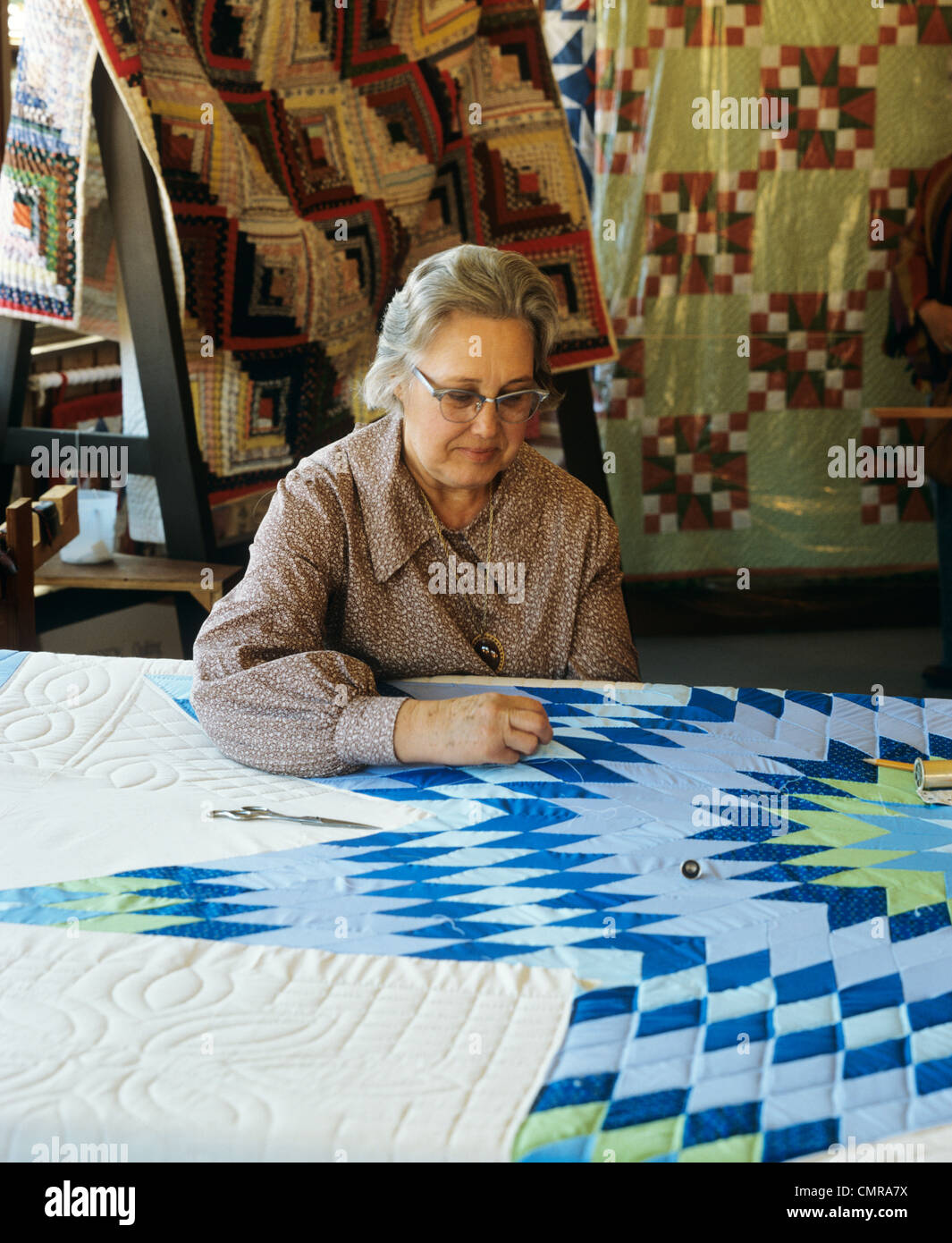 1980s 1970s SENIOR WOMAN QUILTING SEWING QUILT WITH BLUE STAR PATTERN ...