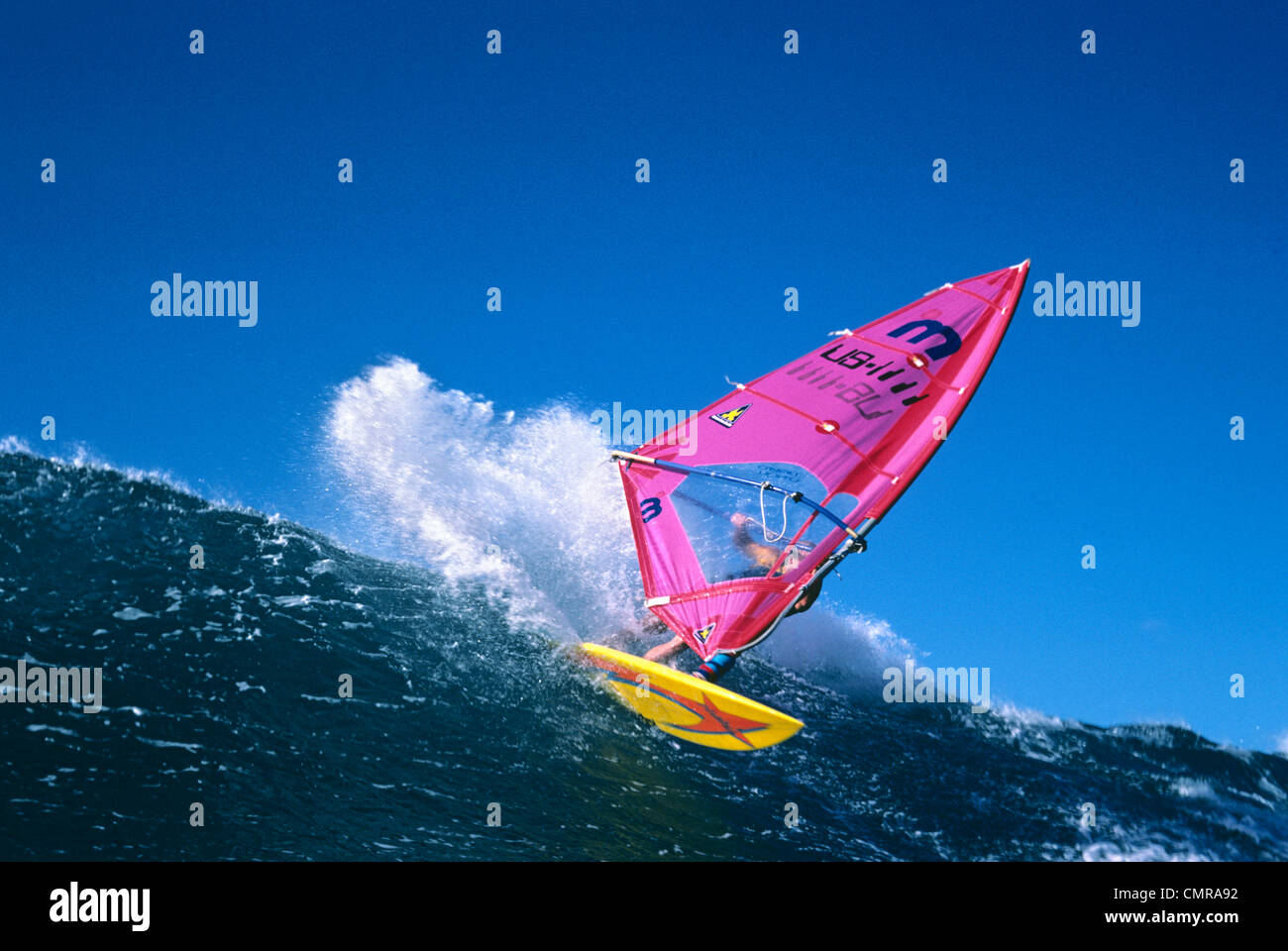 1980s WIND SURFING PINK SAIL YELLOW BOARD Stock Photo - Alamy