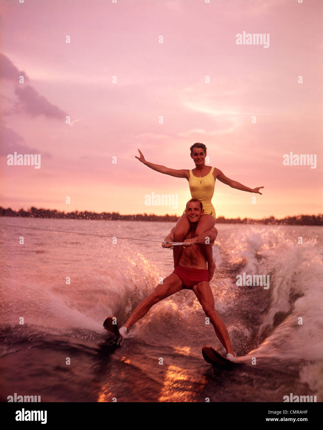 1960s Couple Water Skiing Woman Yellow Bathing Suit Riding On The