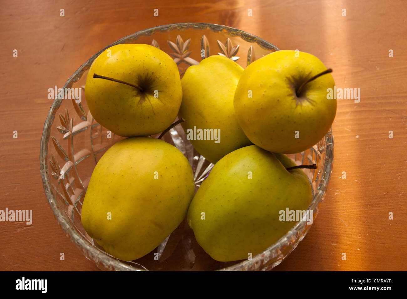 golden delicious apples in crystal fruit bowl still life Stock Photo ...