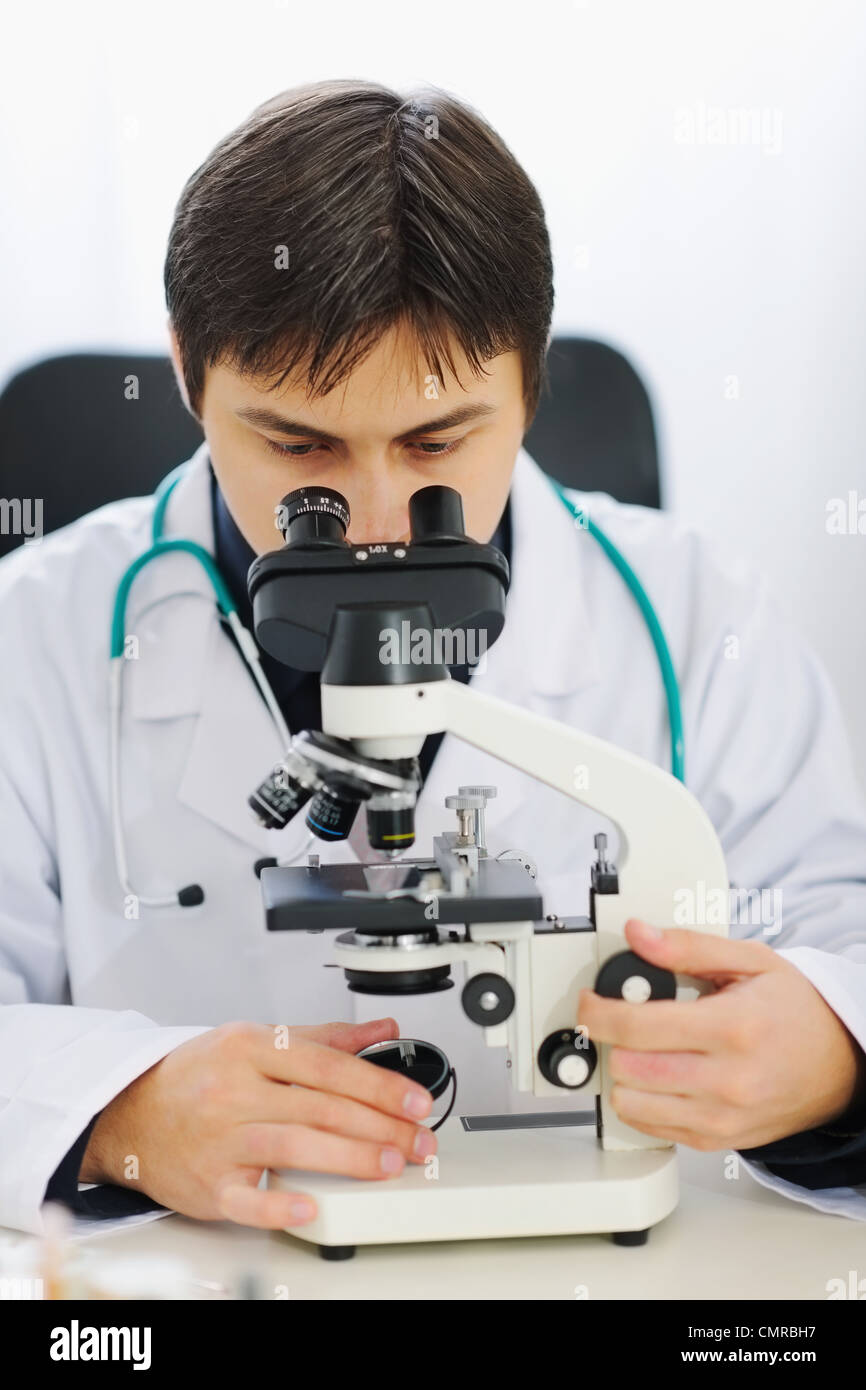Male researcher working with microscope Stock Photo - Alamy