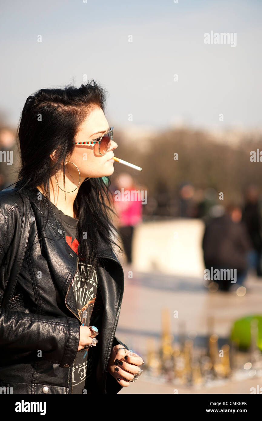 Young woman smoking a cigarette outdoor Stock Photo - Alamy
