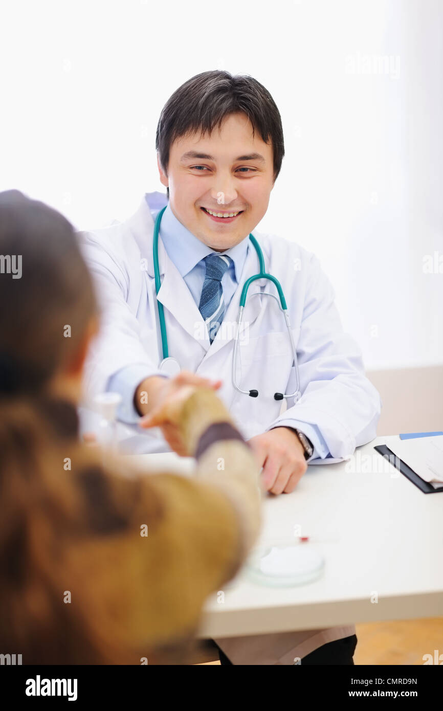 Happy medical doctor and patient shaking hands Stock Photo - Alamy