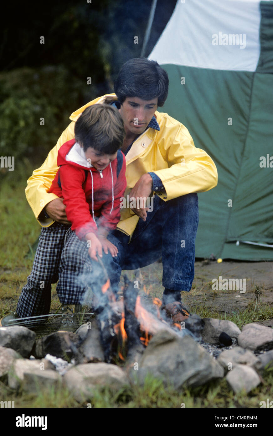 1970s FATHER AND SON BY SMOKY CAMPFIRE Stock Photo - Alamy