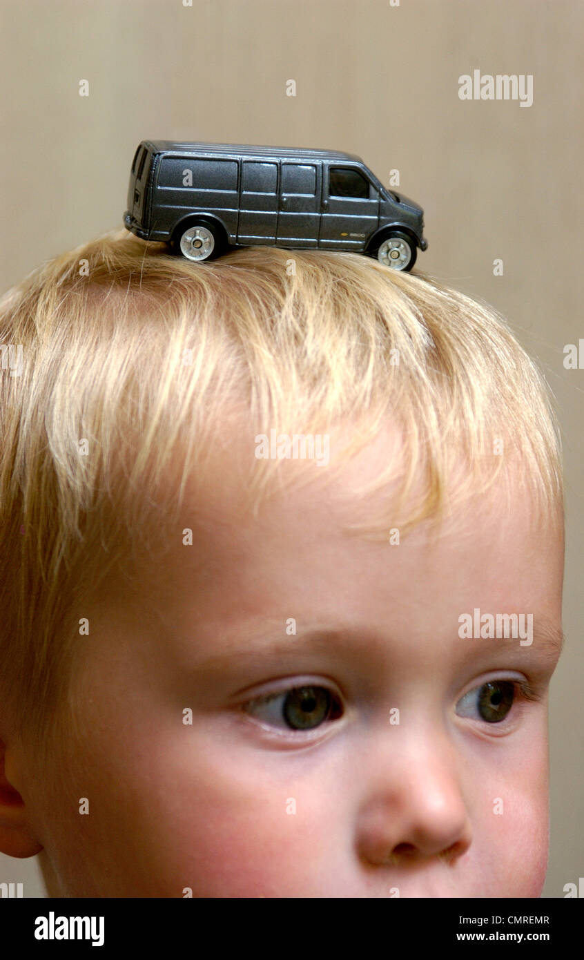 Boy with Toy Car on his Head Stock Photo - Alamy