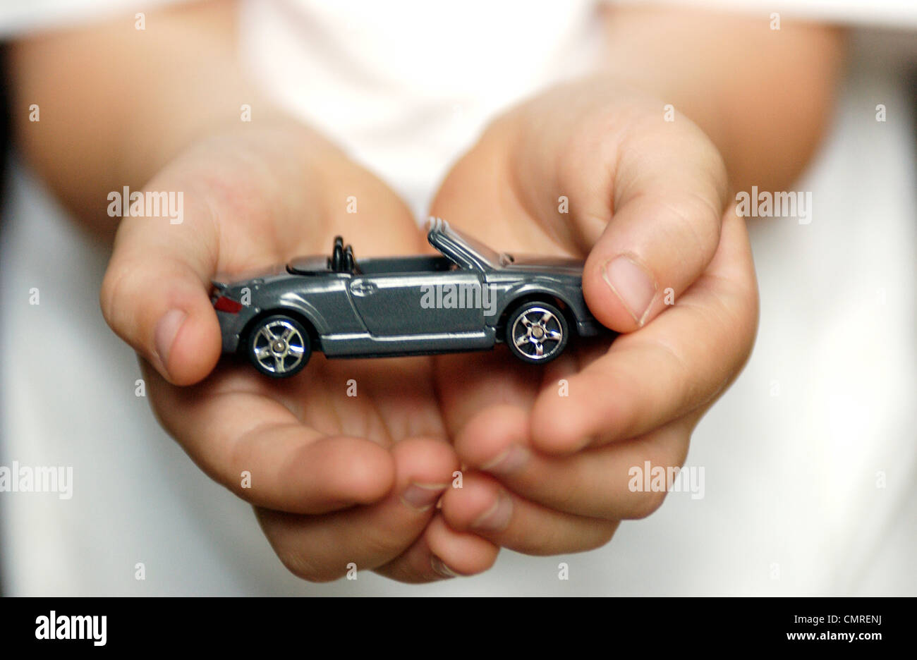 Boy with Toy Car in Hands Stock Photo - Alamy