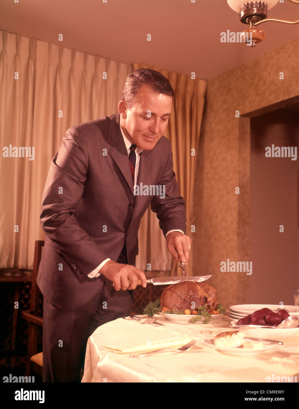 1960s WELL-DRESSED MAN CARVING ROAST BEEF AT DINNER TABLE Stock Photo ...