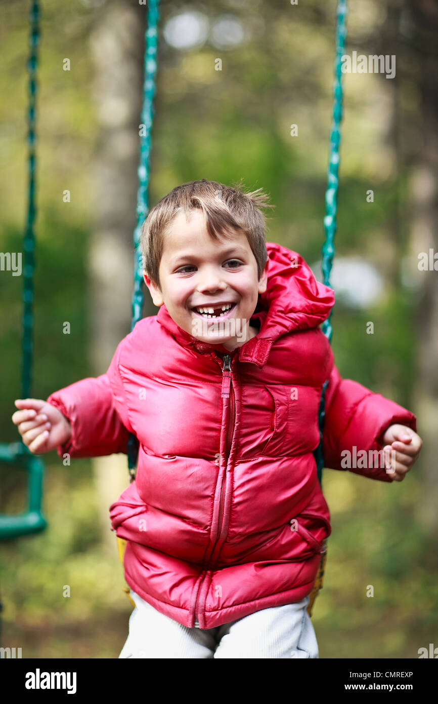 Boy with missing tooth, playing on swing, Gimli, Manitoba Stock Photo ...