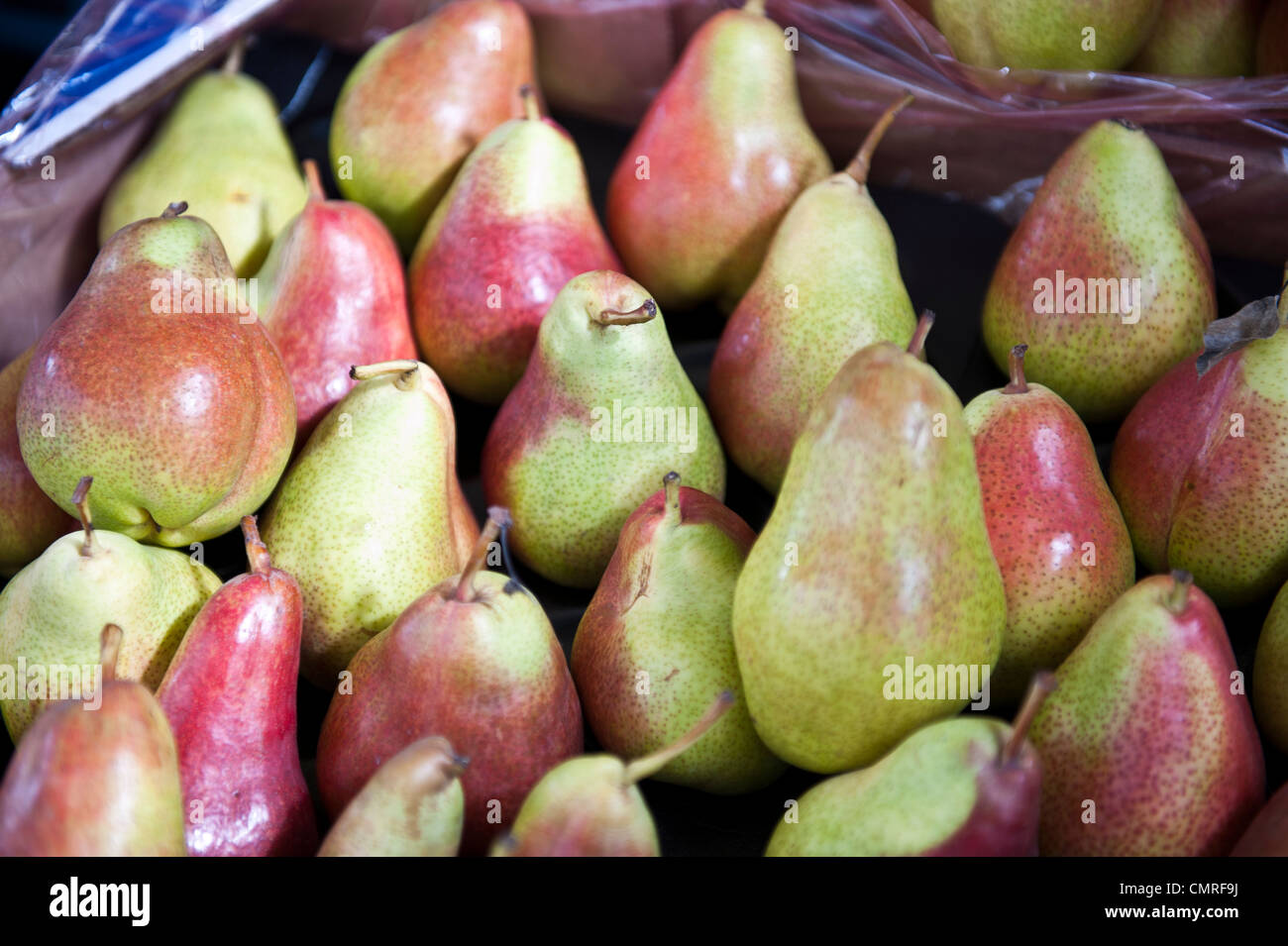 Reddish green pears in a padded brown plastic bag container Stock Photo ...