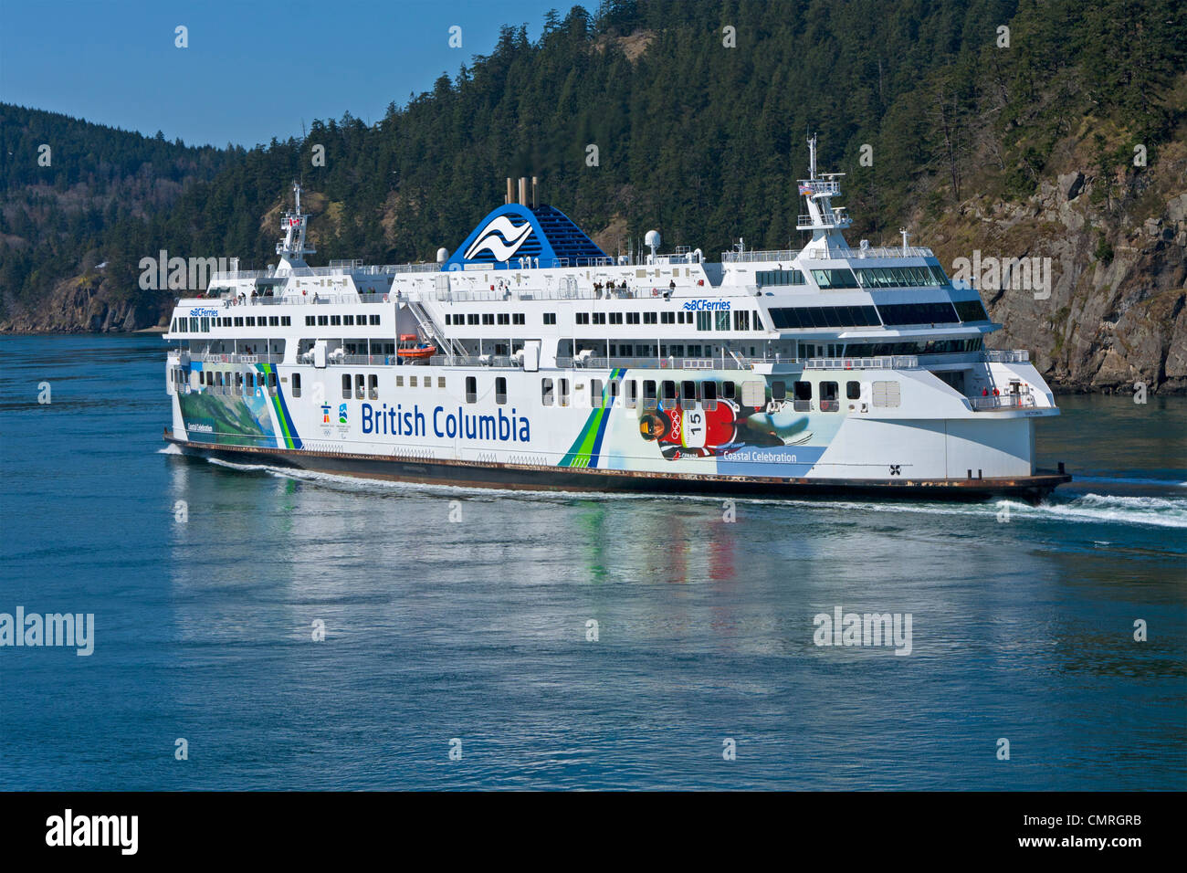 A BC ferry passing through active pass at the southern tip of Galiano ...