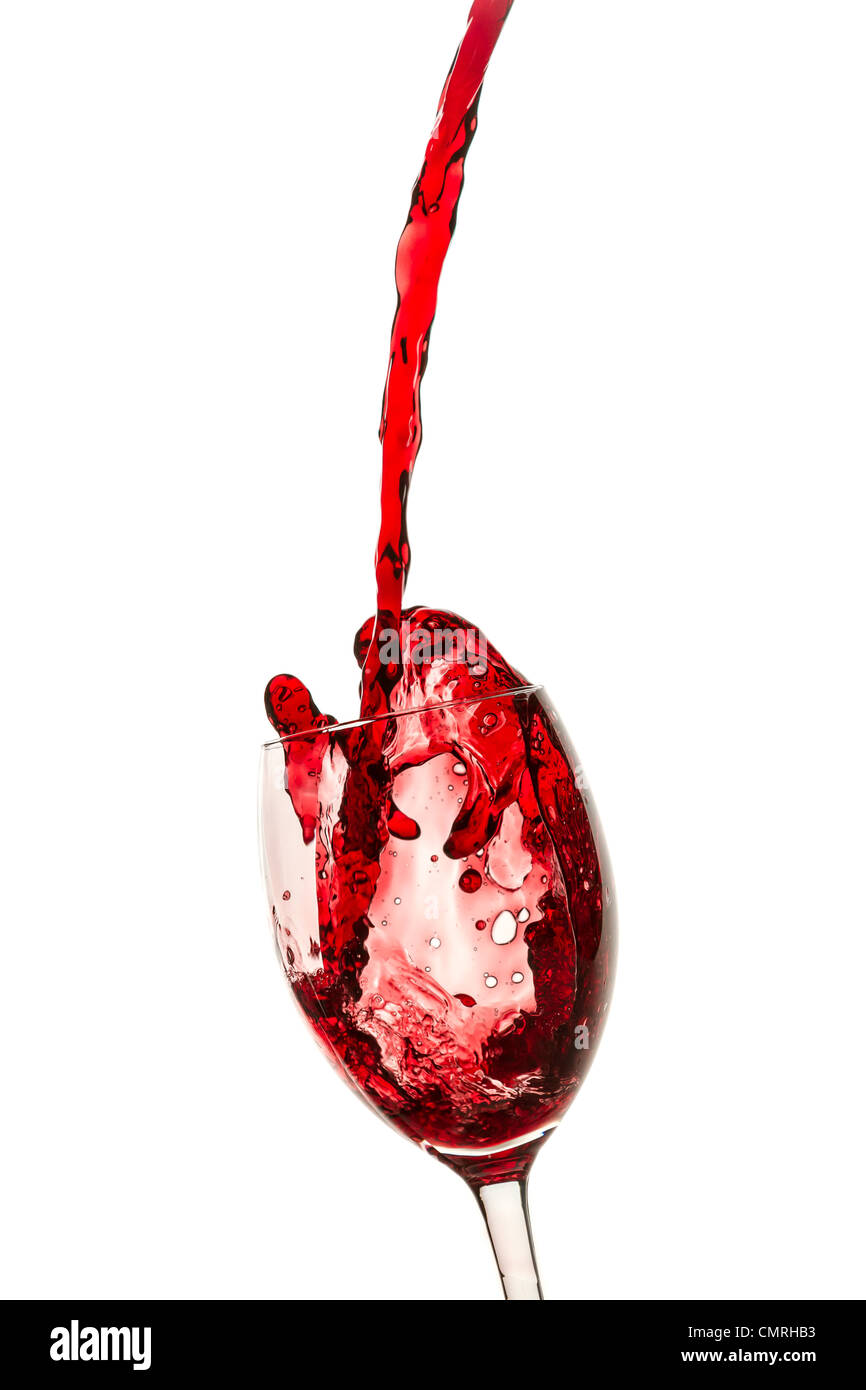 Spilling red wine in the glass on white background Stock Photo - Alamy