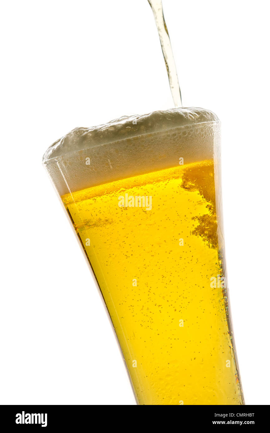 Pouring light beer into glass on white background Stock Photo - Alamy