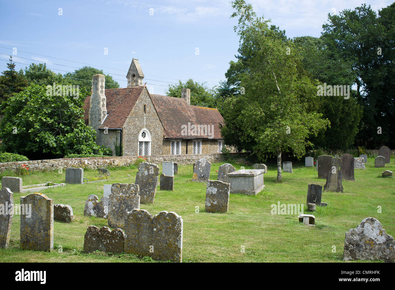 Traditional English church vicarage or rectory and graveyard with ...