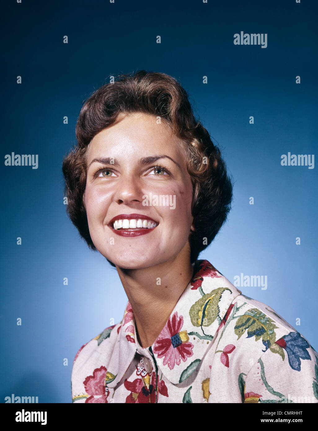 1960s SMILING WOMAN IN WHITE PRINT DRESS LOOKING UP STUDIO Stock Photo ...