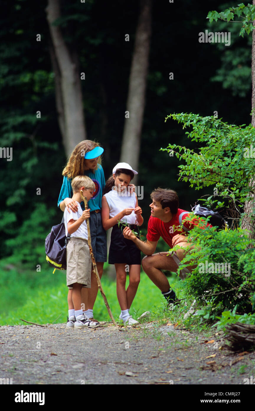 1990s FAMILY HIKING IN MOUNTAINS LEARNING ABOUT NATURE Stock Photo - Alamy