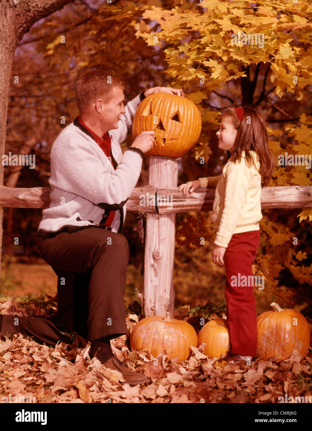 1960s Man Father And Girl Daughter Carving Halloween Jack O Lantern