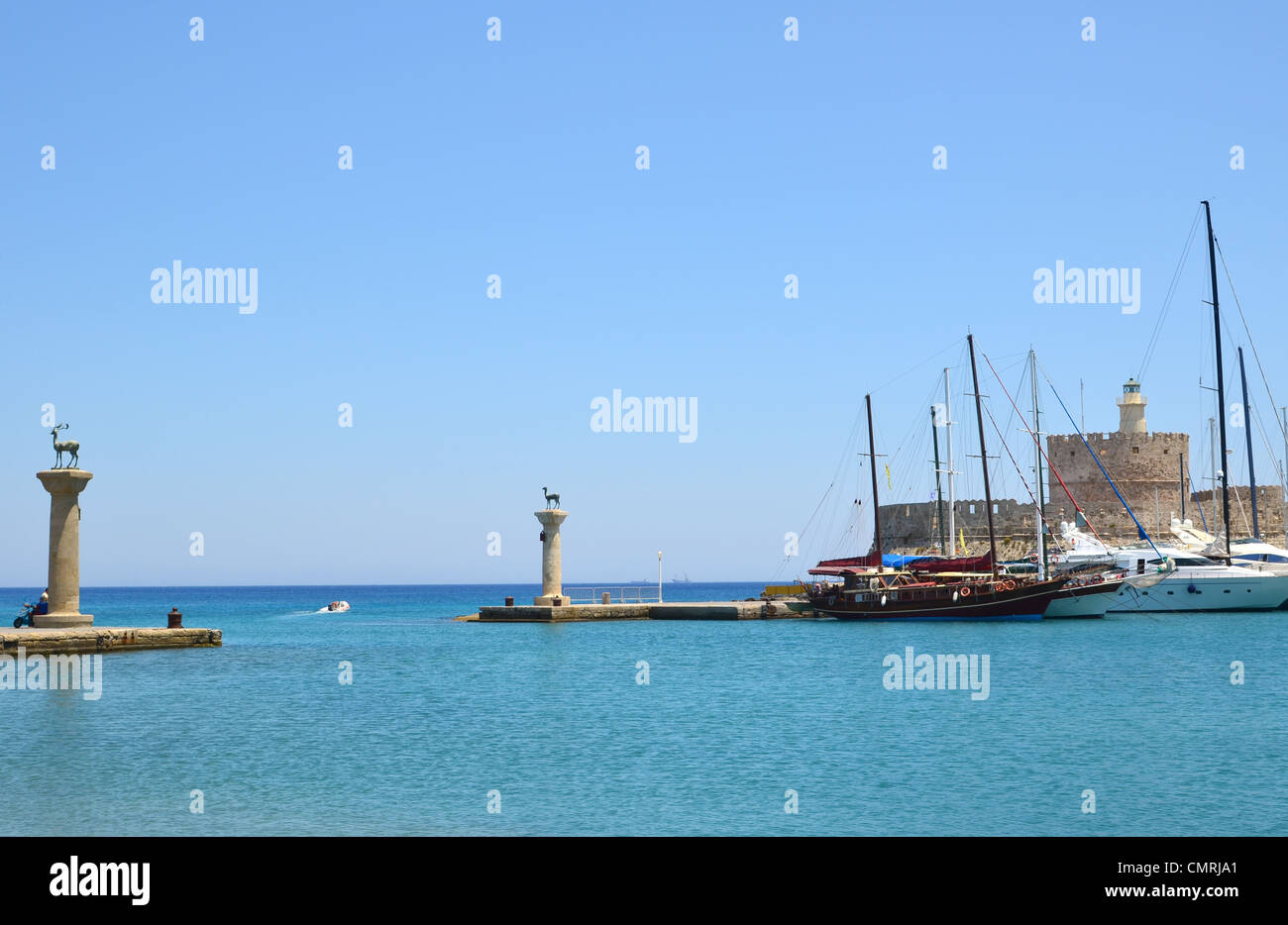 Entrance to the harbour at Rhodes past the two Mandrake statues, Greece ...