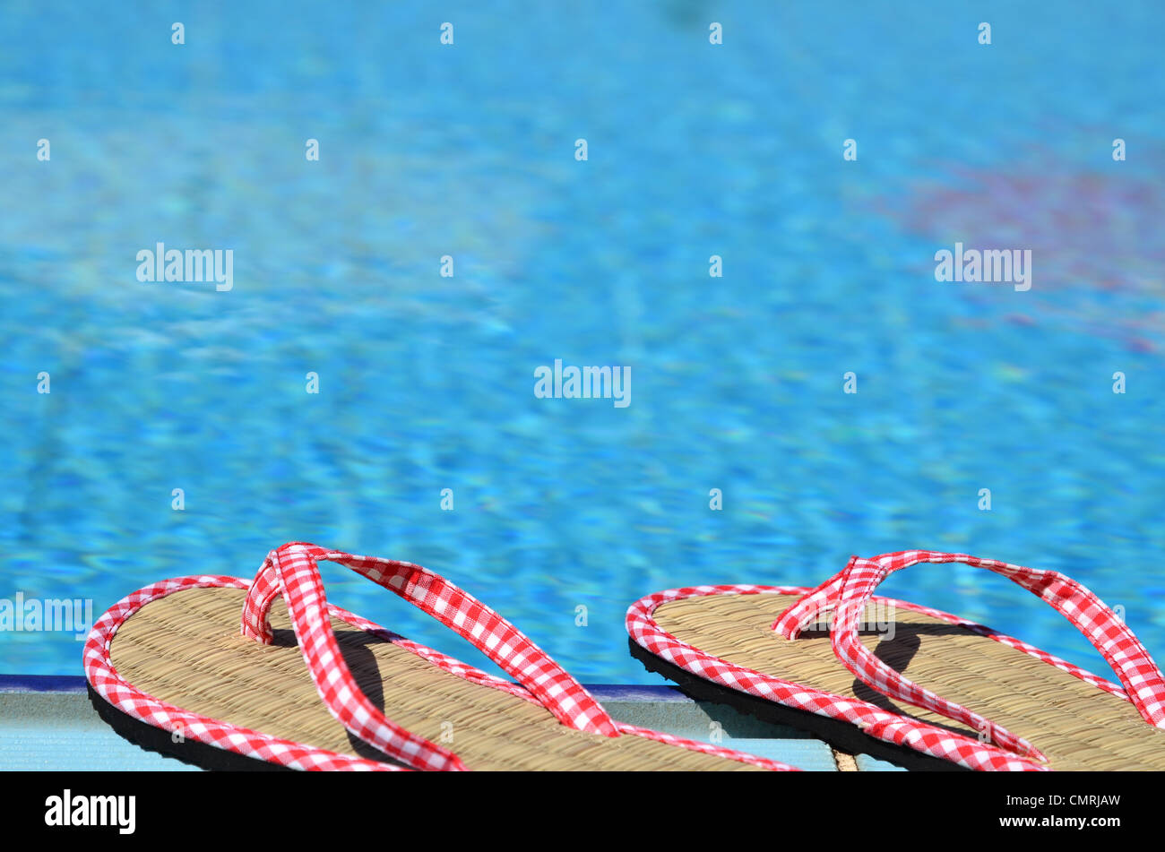 Pair of flip-flops beside a swimming pool Stock Photo - Alamy