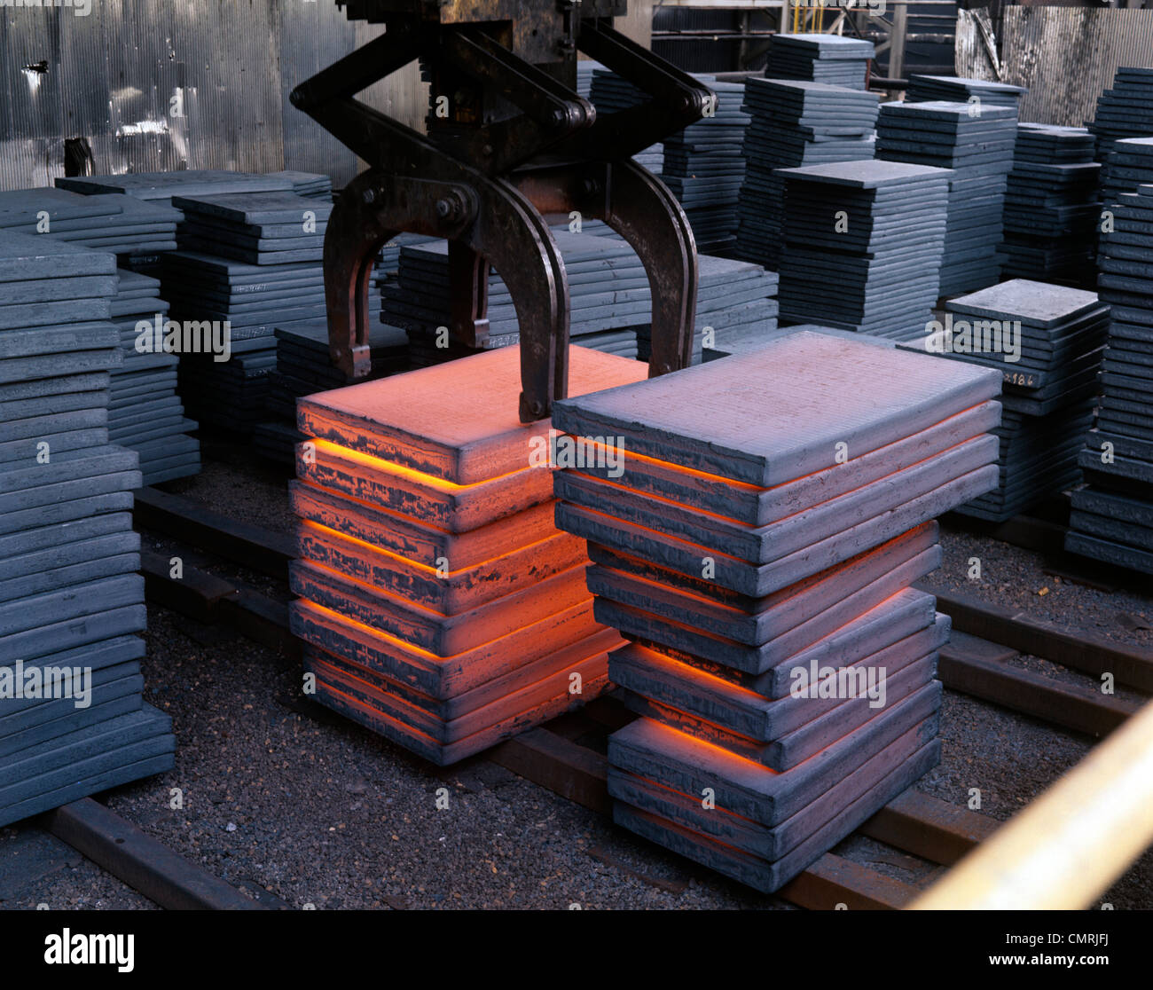 1980s STEEL MILL INTERIOR CRANE LIFTING HOT INGOTS OF GLOWING STEEL ...