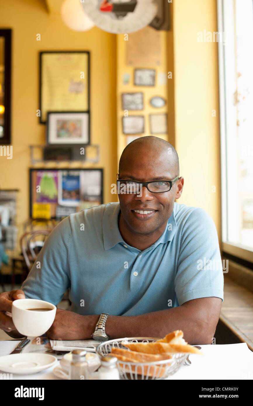 African American man drinking coffee in restaurant Stock Photo - Alamy