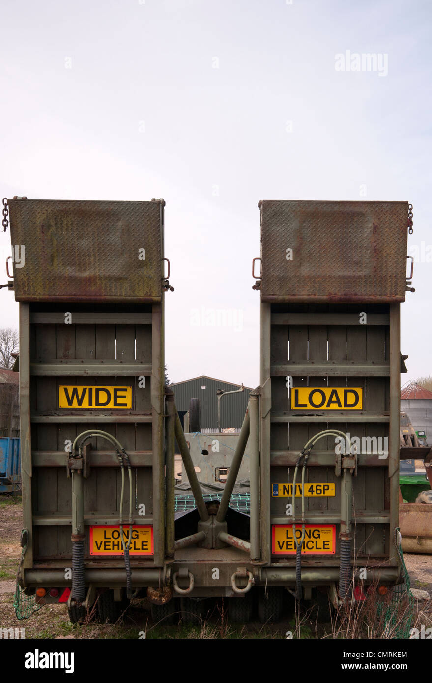 Rear Of A Low Loader Trailer With Wide Load and Long Vehicle Signs ...