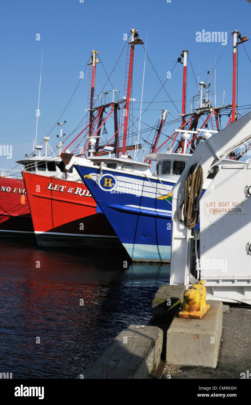 Bows of steel hulled fishing trawlers tied to wharf in New Bedford ...