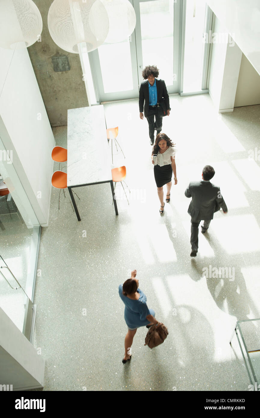 Business people walking in office Stock Photo - Alamy
