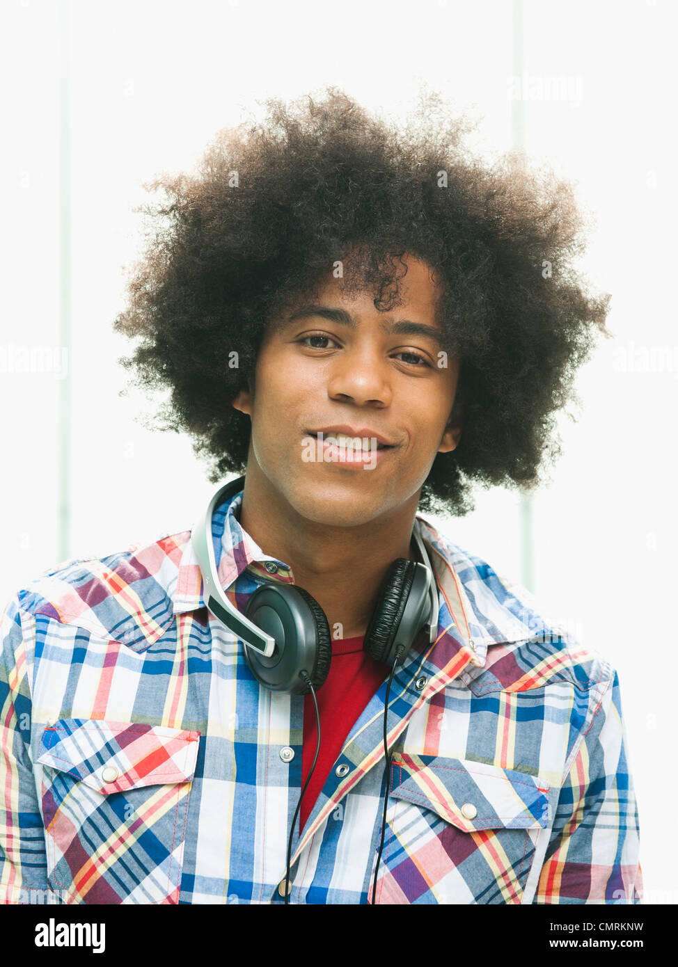 Black man with headphones around neck Stock Photo - Alamy