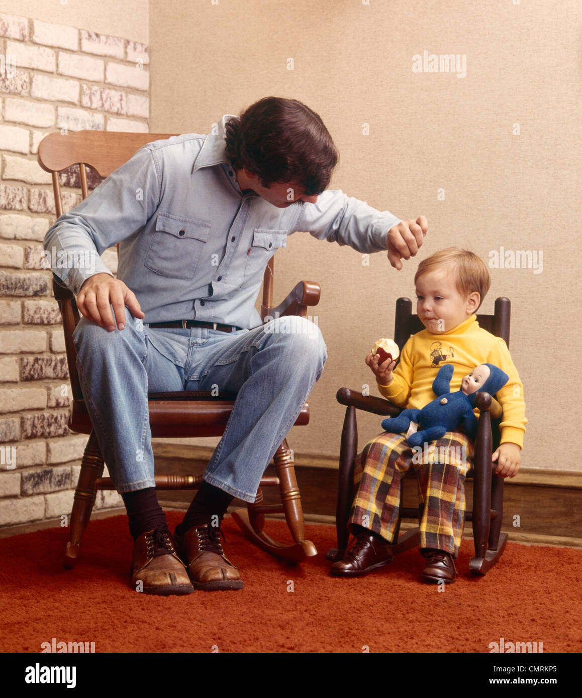 1970 1970s RETRO FATHER SITTING IN ROCKING CHAIR NEXT TO SON TODDLER IN ...
