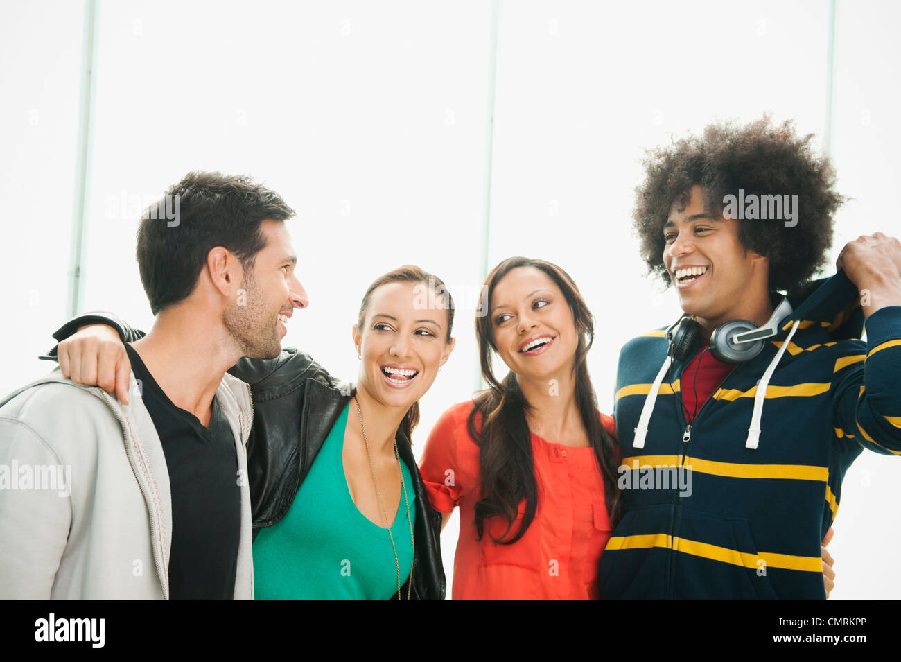 Smiling friends standing together Stock Photo - Alamy