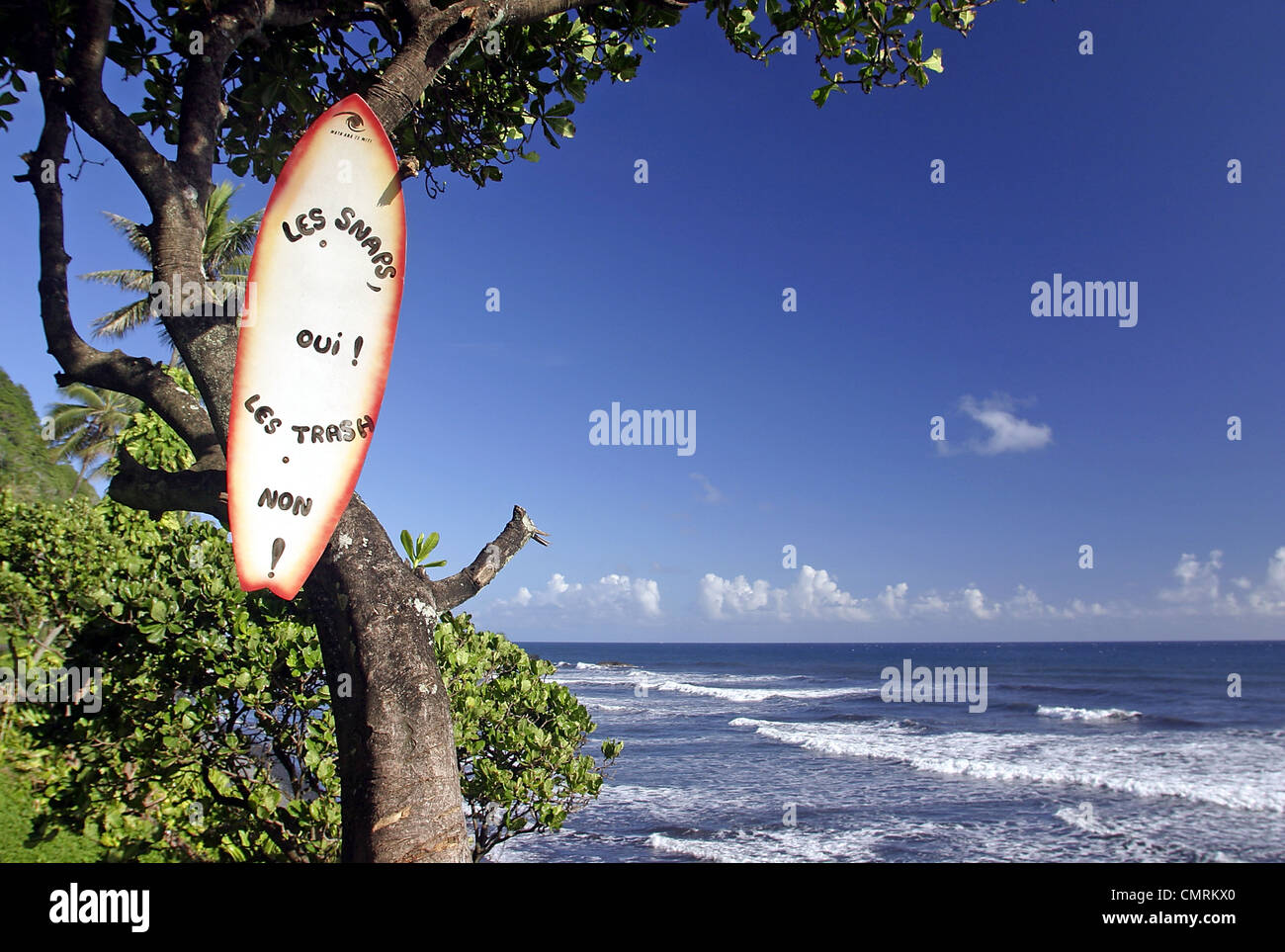 Keep the beach clean sign on surfboard shaped sign attached to tree ...