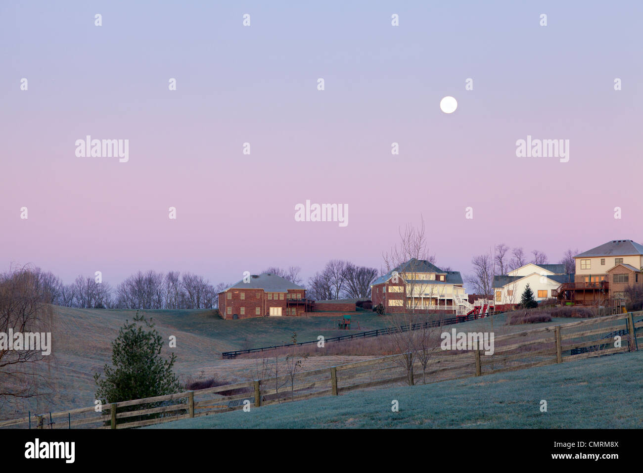 Moon setting in suburbs Stock Photo - Alamy