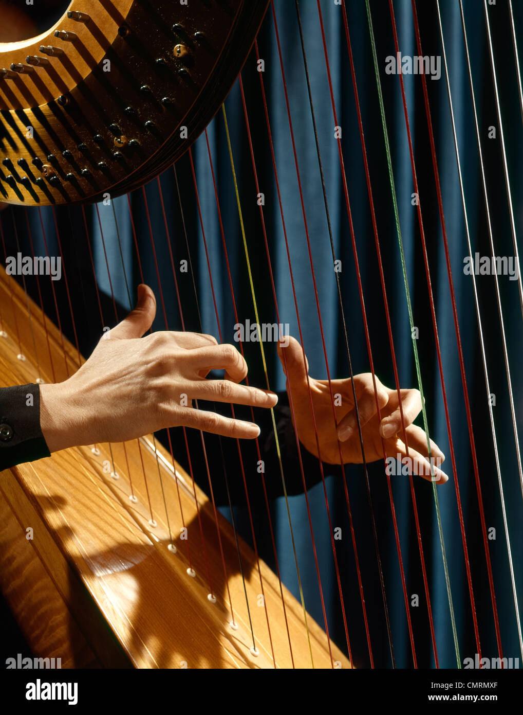 1960 1960s RETRO CLOSE UP OF WOMANS HANDS PLAYING HARP PLUCKING STRINGS ...
