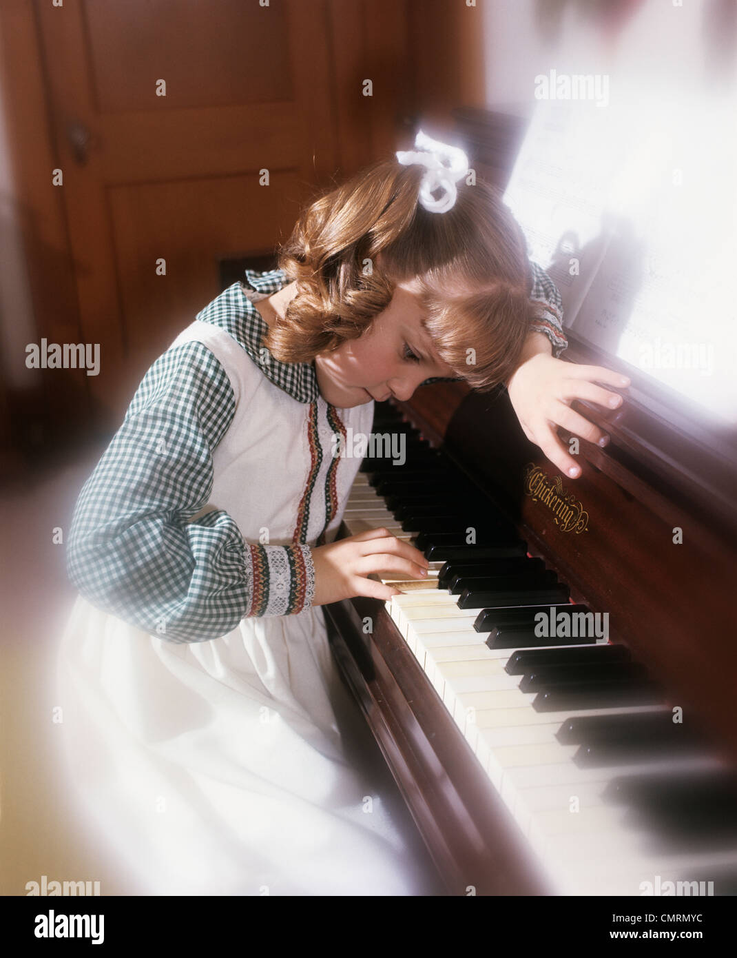 1970s GIRL AT PIANO PRACTICING PLAYING SCALES Stock Photo - Alamy
