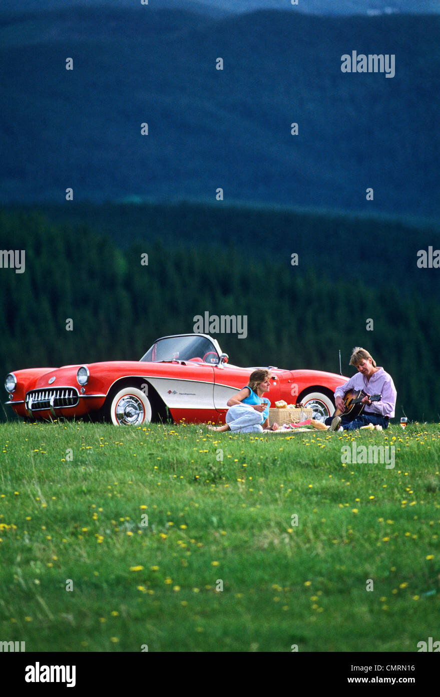 1990 1990s COUPLE MAN WOMAN PICNIC BESIDE VINTAGE CAR WINTER PARK ...
