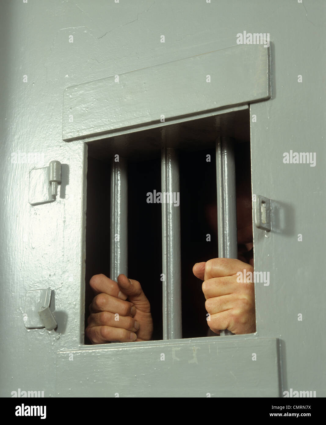 HANDS ON CELL BARS Stock Photo - Alamy