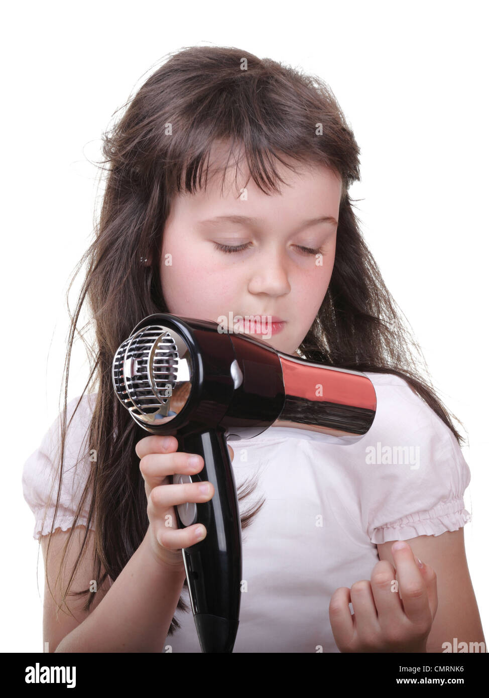 Pretty little girl drying her hair hairdryer isolated on white Stock ...