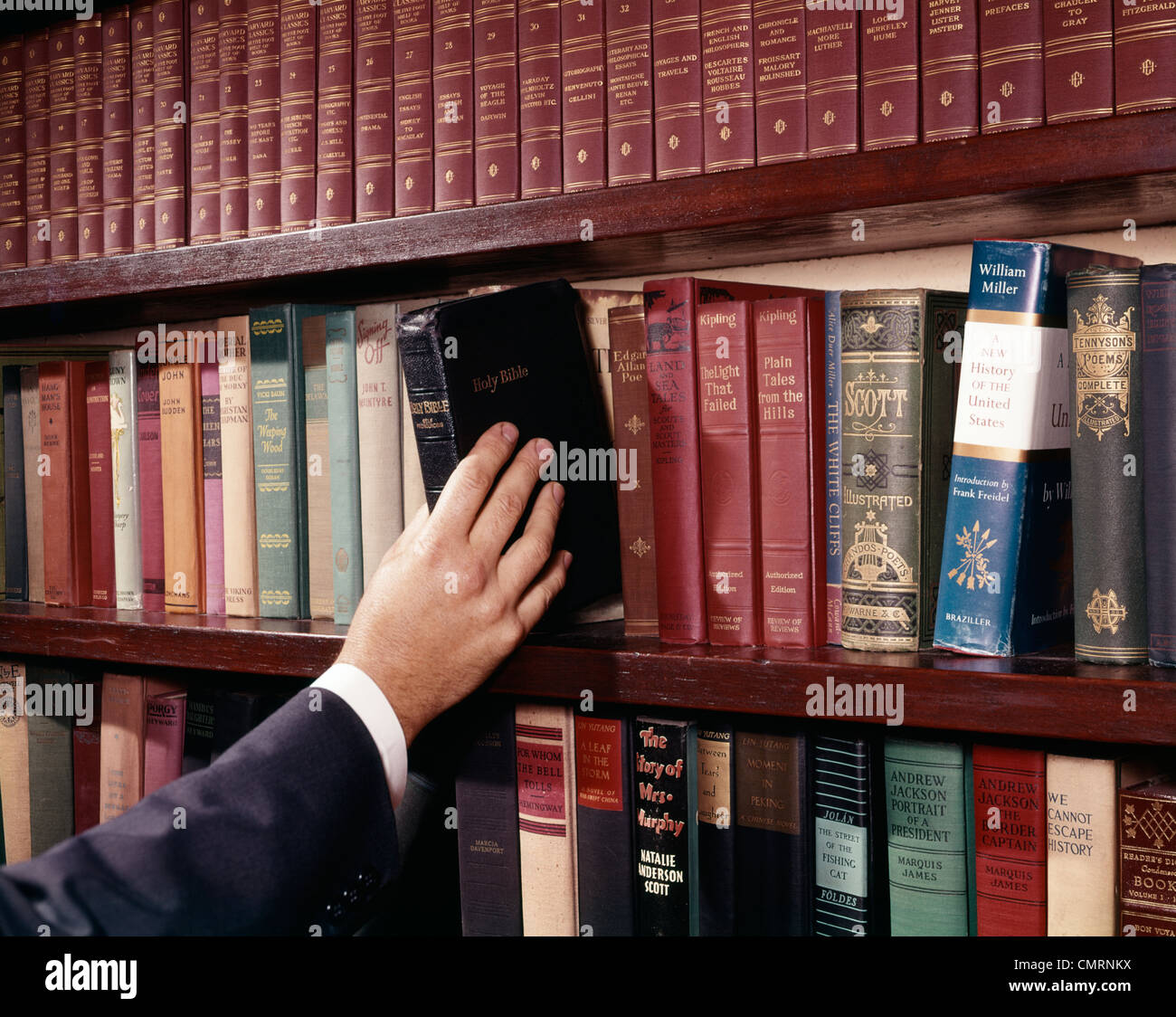 1960 1960s MAN HAND REACHING BIBLE LIBRARY BOOKS Stock Photo - Alamy