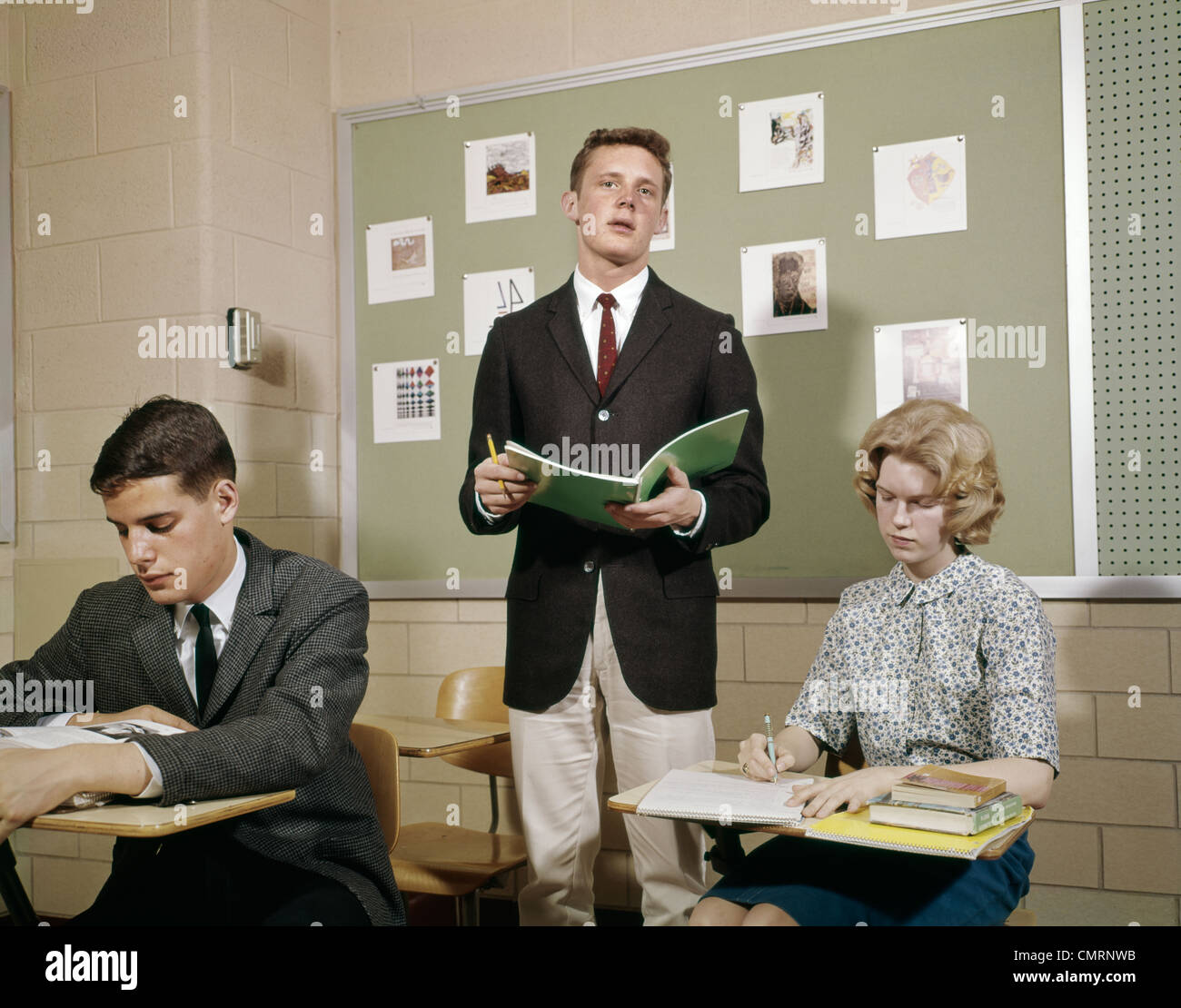 1960s TEEN STUDENTS BOYS GIRLS CLASSROOM BOY STANDING READING FROM ...