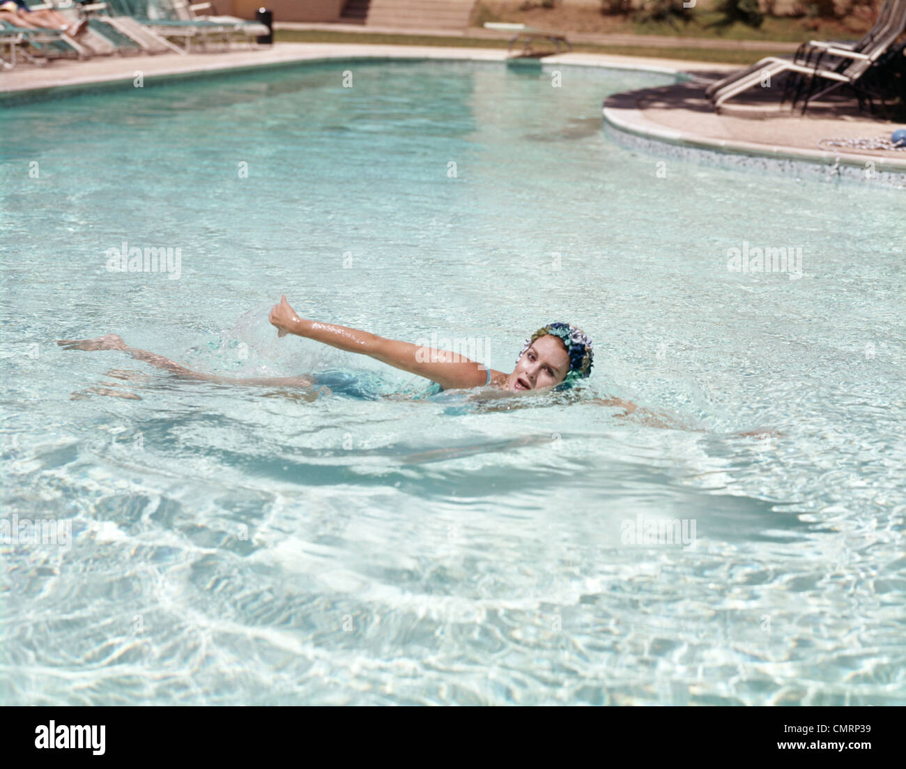 1960s WOMAN BLUE BATHING CAP SWIMMING IN WATER POOL OVERHAND STROKE ...