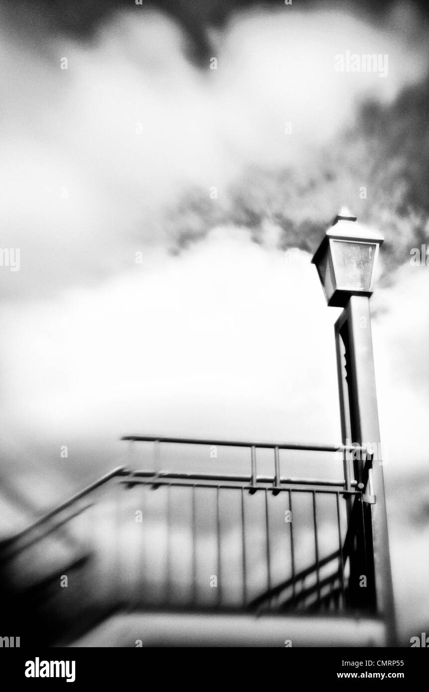 Lamp post on a stairway with railings and puffy clouds, Longueuil ...