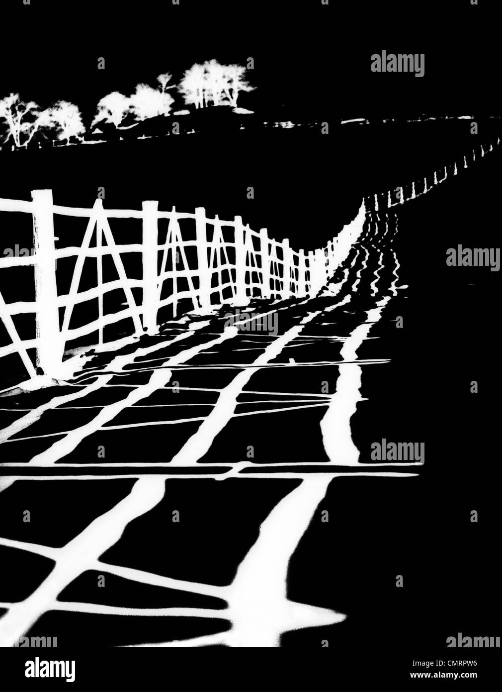 1970s POSTERIZATION OF POST & RAIL FENCE CASTING SHADOW ON GROUND WITH ...