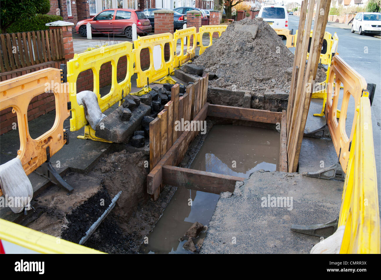 Excavation on a street in a built up area Stock Photo - Alamy