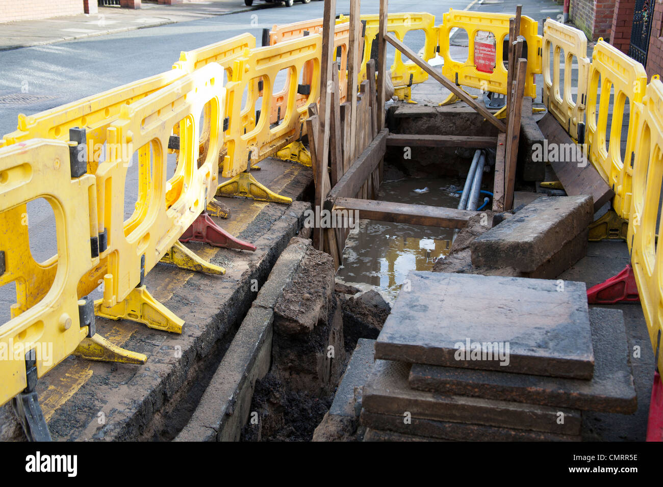 Excavation on a street in a built up area Stock Photo - Alamy