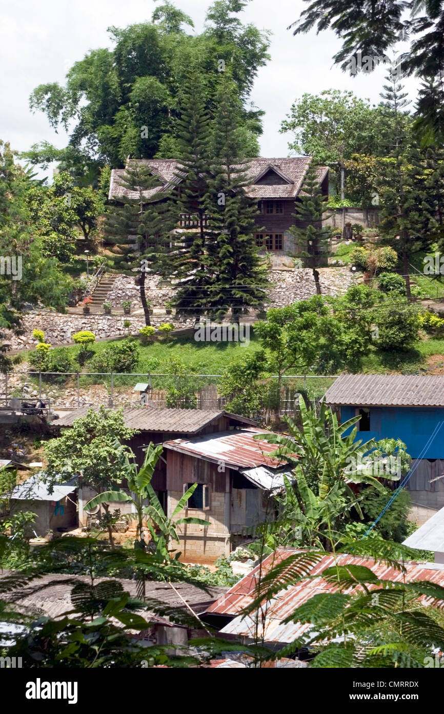 A neighborhood with houses is viewed from above in Chiang Rai, Thailand ...