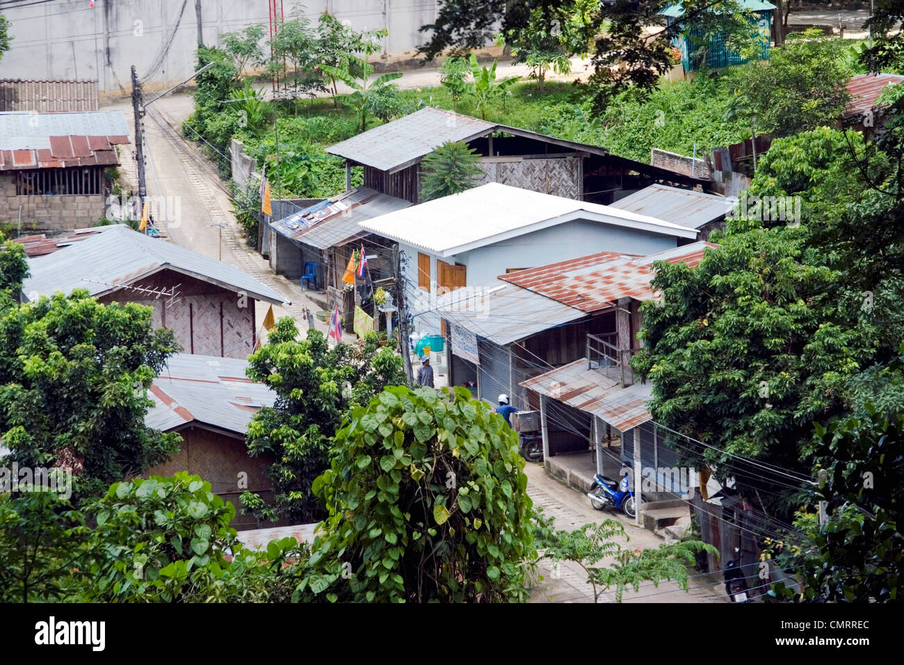 A neighborhood with houses is viewed from above in Chiang Rai, Thailand ...