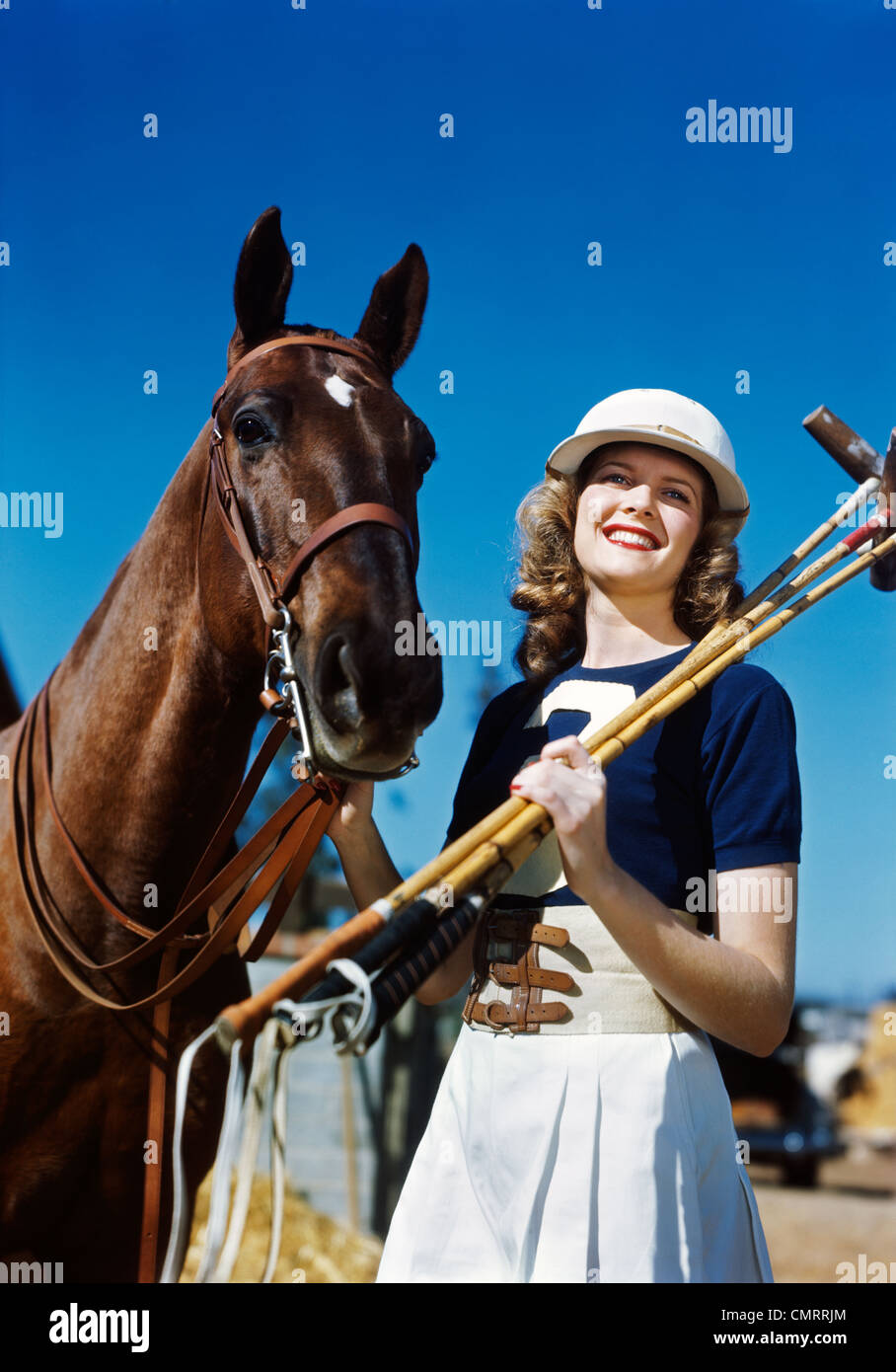 1940s 1950s SMILING WOMAN POLO PLAYER HOLDING MALLETS STANDING BY HORSE ...