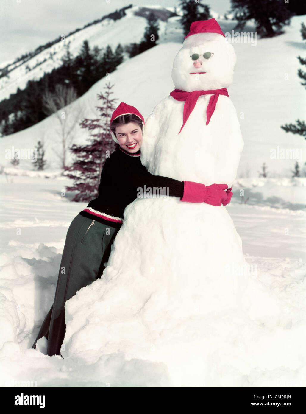 1940s 1950s SMILING WOMAN HUGGING SNOWMAN Stock Photo - Alamy