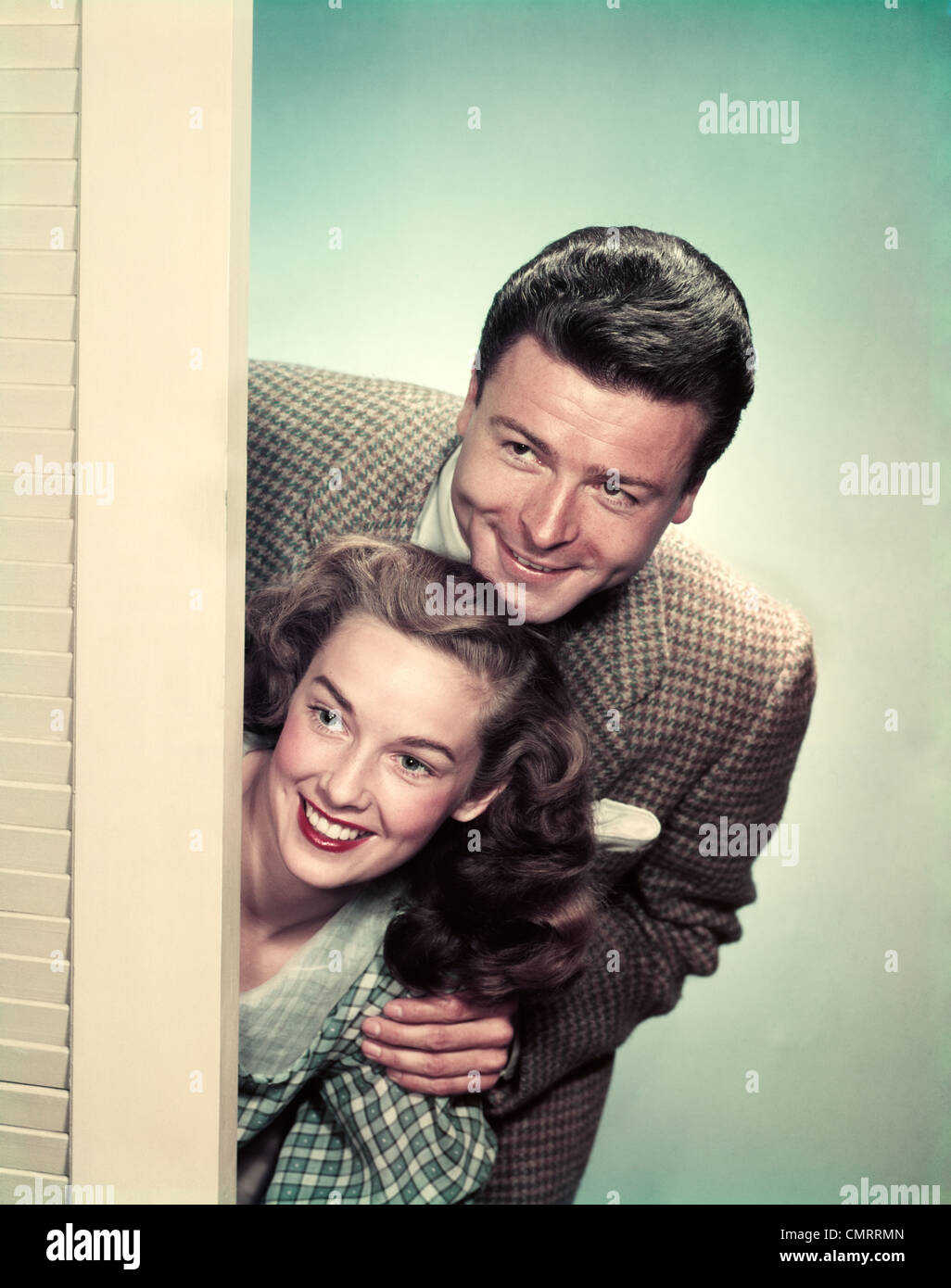 Woman peeking around corner hi-res stock photography and images - Alamy