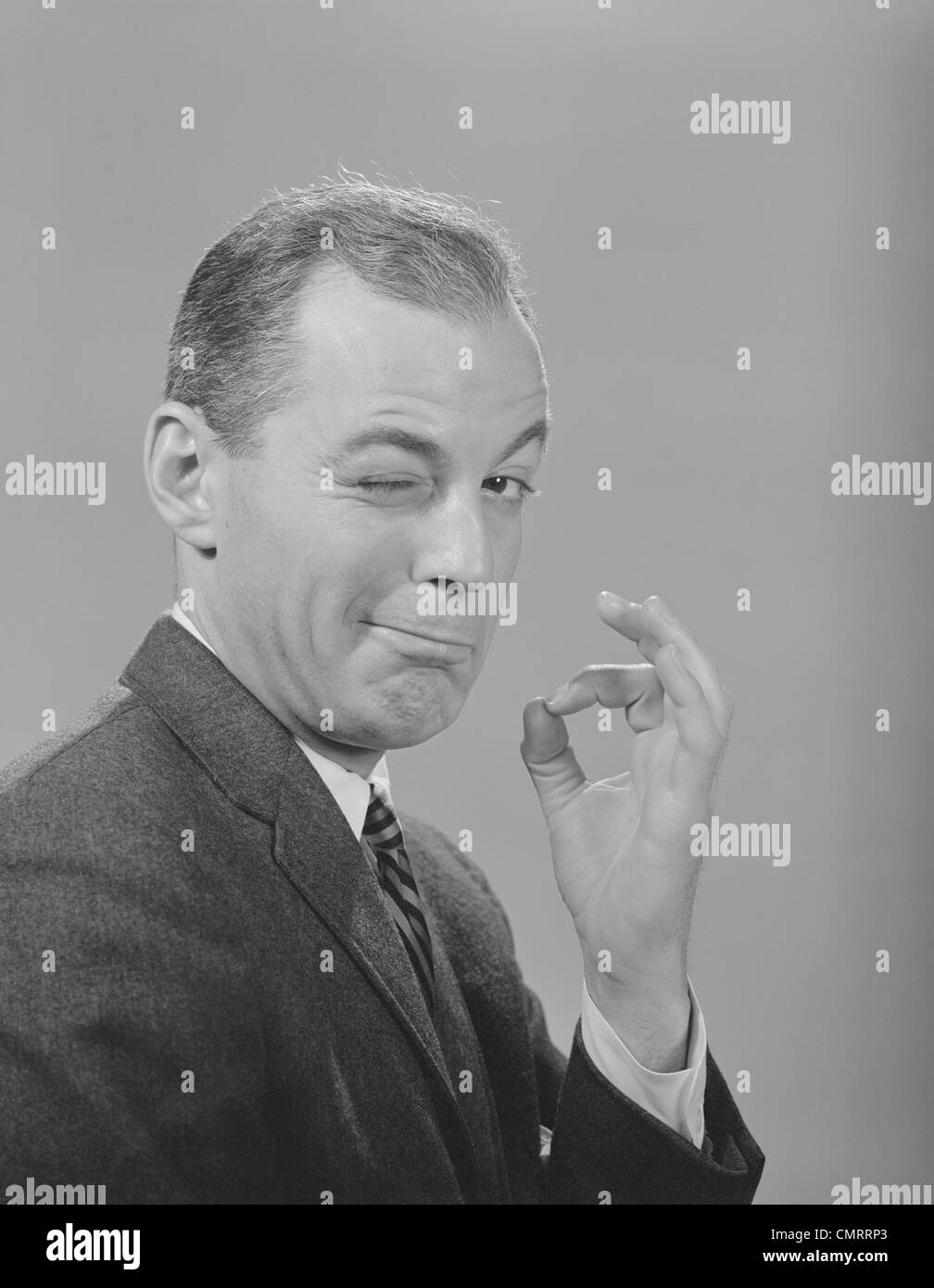 1950s 1960s MAN WINKING EYE MAKING OKAY GESTURE SIGN WITH THUMB AND ...